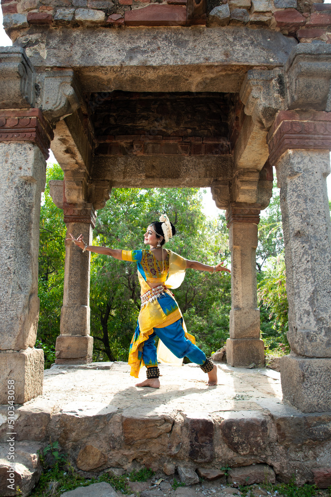 Indian woman Odissi dancer doing classical dance form outdoor at ...