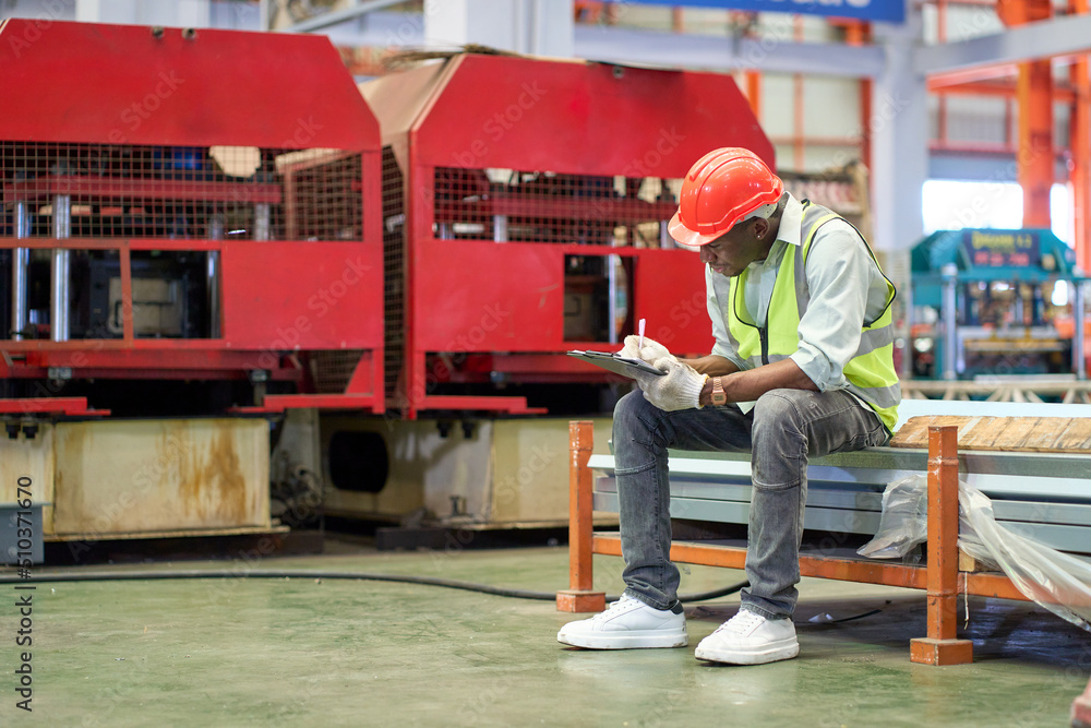 Areican American foreman sitting and lecturing on paper chart for ...