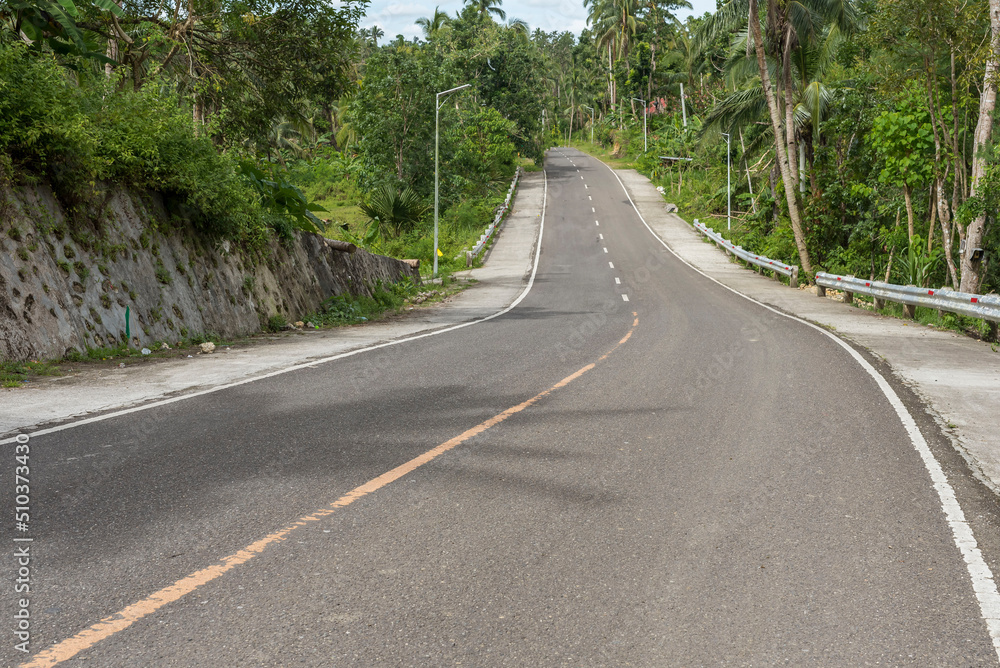 An asphalted two lane highway traversing Central Bohol, Philippines ...