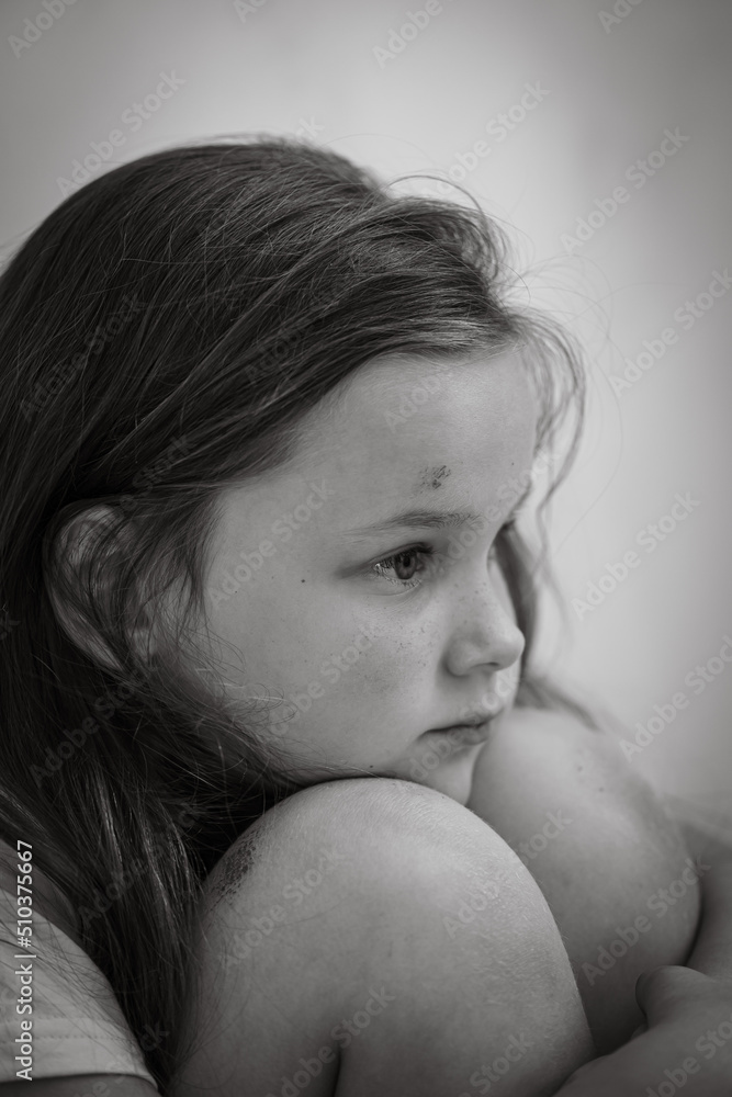 Black and white portrait of little sad shocked wounded girl with long ...