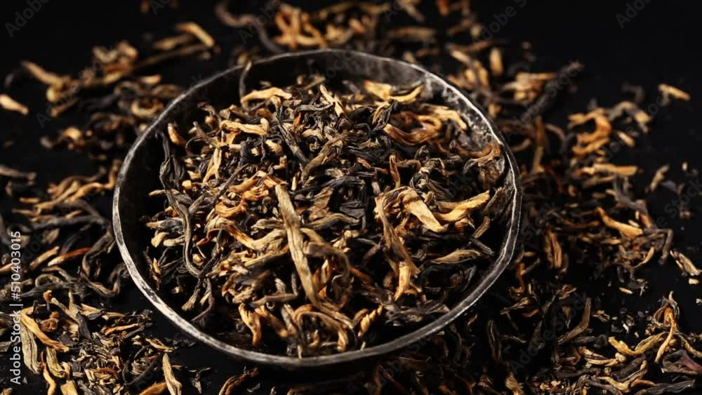 Dried red tea leaves in a black metal bowl close up. Macro. Loose ...