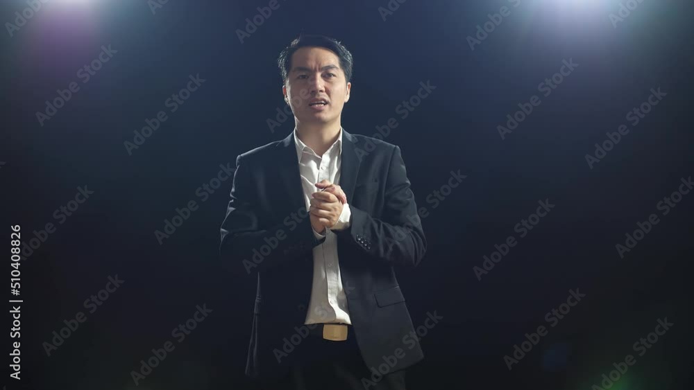 Asian Speaker Man In Business Suit Holding His Hands Together And ...