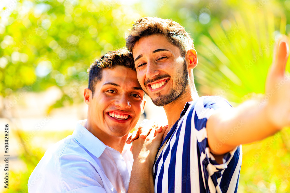 Happy Gay Couple Taking A Selfie With Mobile Smart Phone Camera In