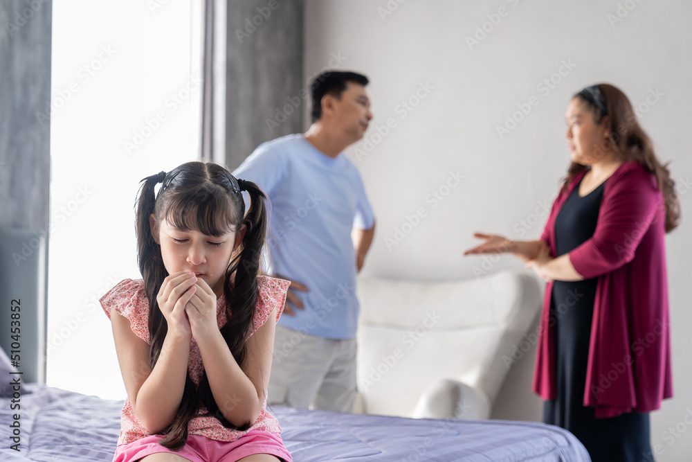 Sad child girl crying with wet eyes from tears from father and mother ...