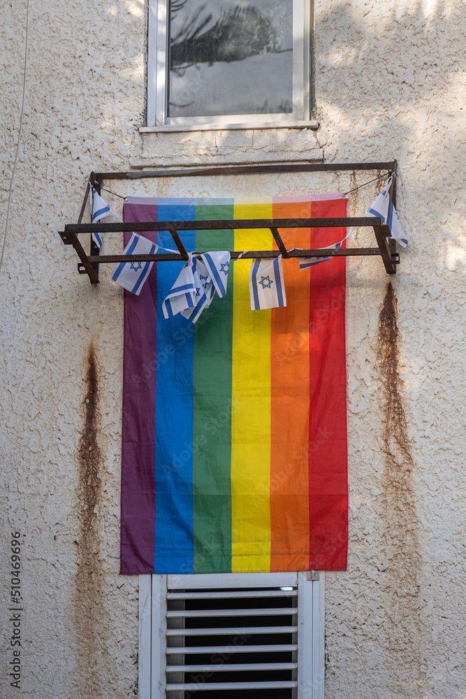 Pride flag next to Israeli flags outside a window during LGBT pride ...