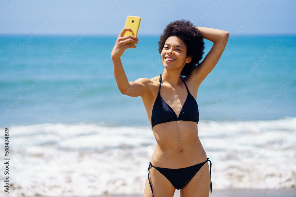 Content Black Woman In Bikini Taking Selfie On Beach Stock Photo content-black-woman-in-bikini-taking-selfie-on-beach-stock-photo