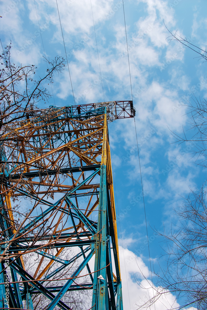 Close-up view of an electric tower with a beautiful blue sky background ...
