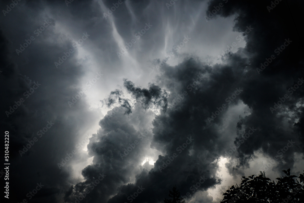 Dark, gloomy, stormy, rainy sky with rays of light. Terrible hurricane ...