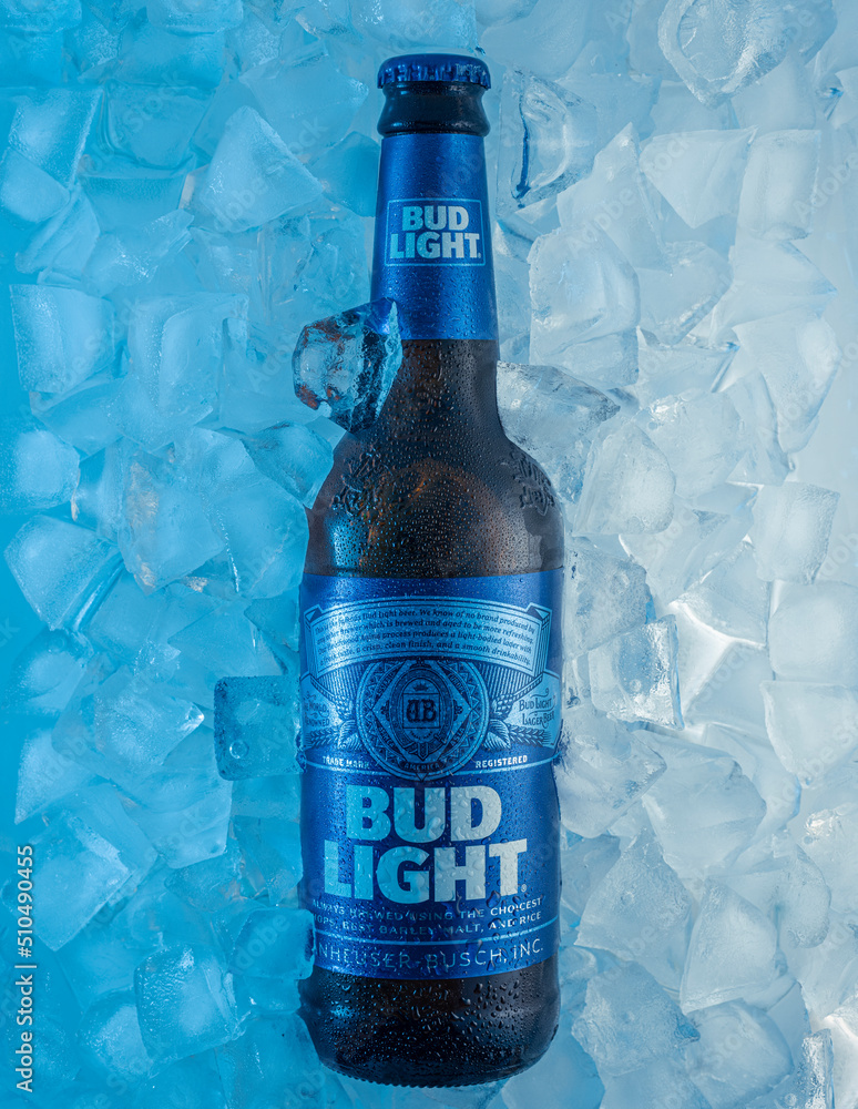 bottle of Bud Light lies in ice cubes. Bud Light is one of the best ...