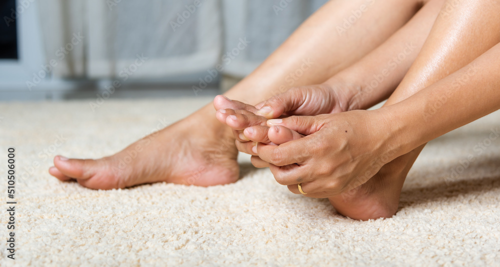Foot pain, Asian woman holds her toe injury feeling pain her foot at ...