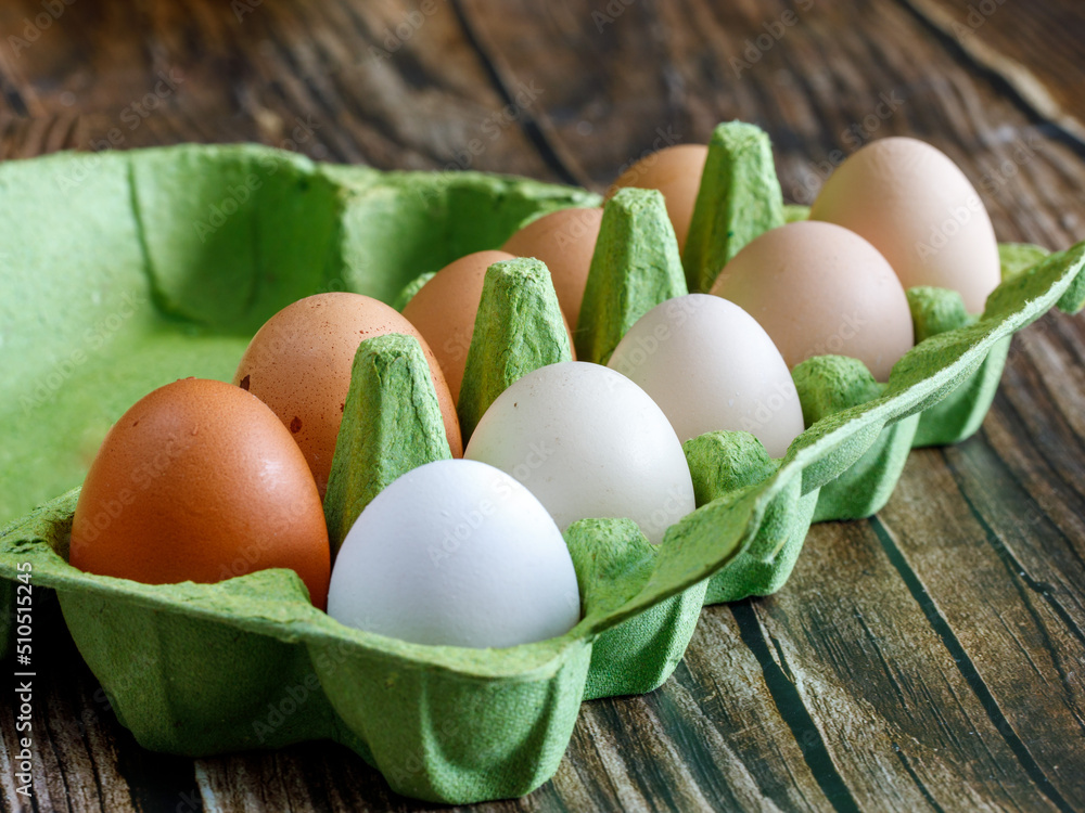 Colorful organic chicken eggs in green egg carton. These eggs were ...