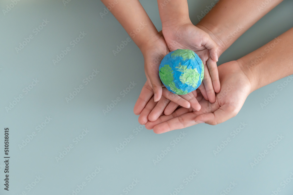 Hands holding earth paper and water paint. Concept of protecting the ...