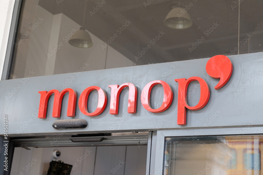 Monop' logo sign and text brand on city building of supermarket facade ...