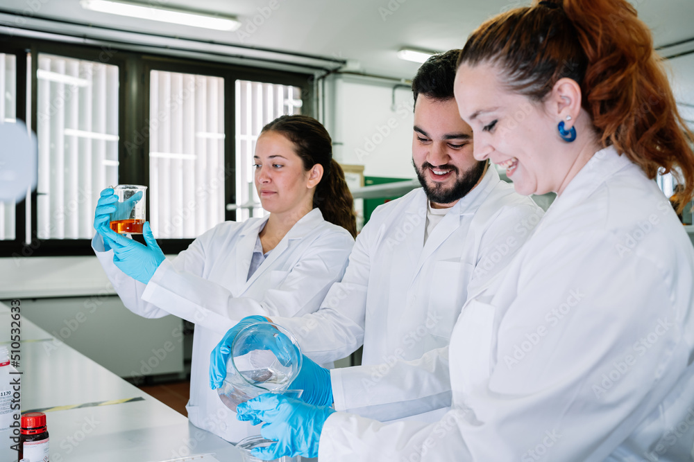 Content scientists conducting experiment with liquids in lab Stock ...
