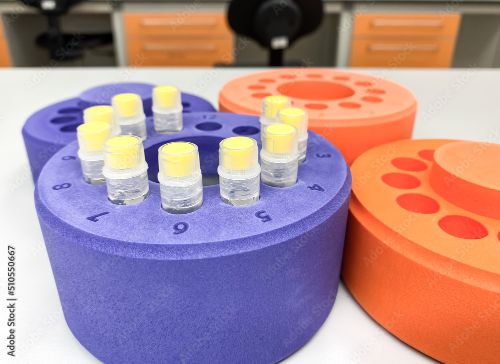 Set of cryovials in purple container for cryopreservation of biological ...