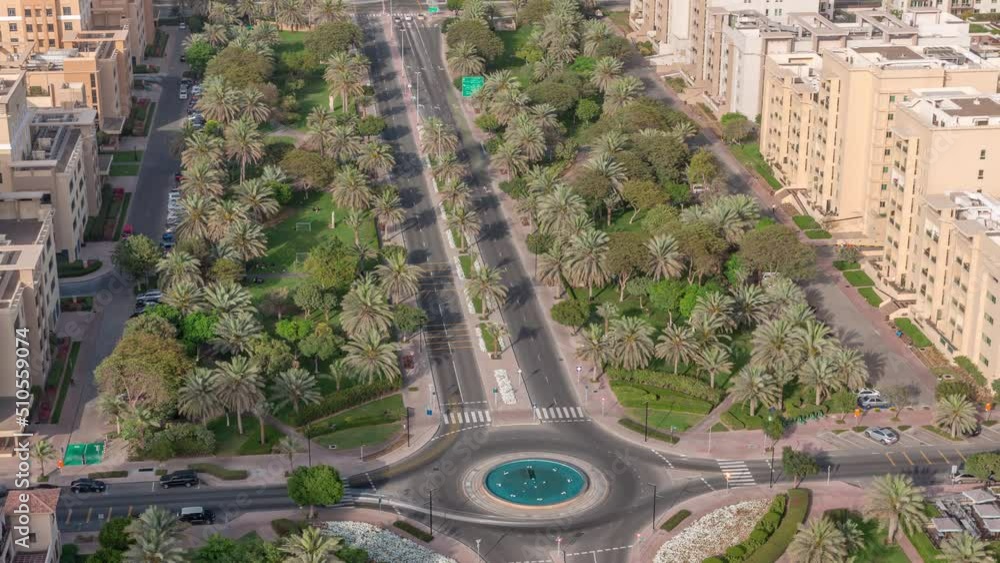 Traffic on a road intersection with roundabout in Greens district with ...