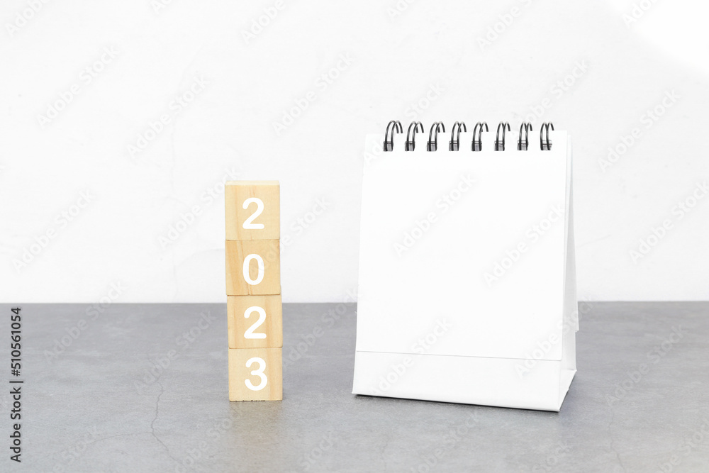 Blank calendar mockup of New Year 2023 on a wooden cube stone table on ...