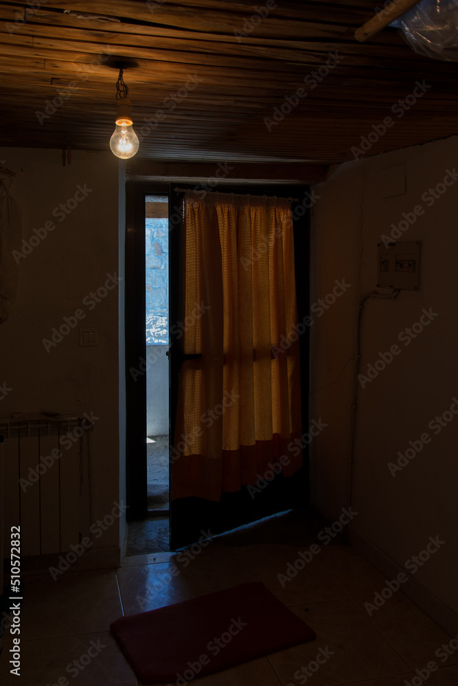 Creepy door half open in an old house with light bulb hanging from ...