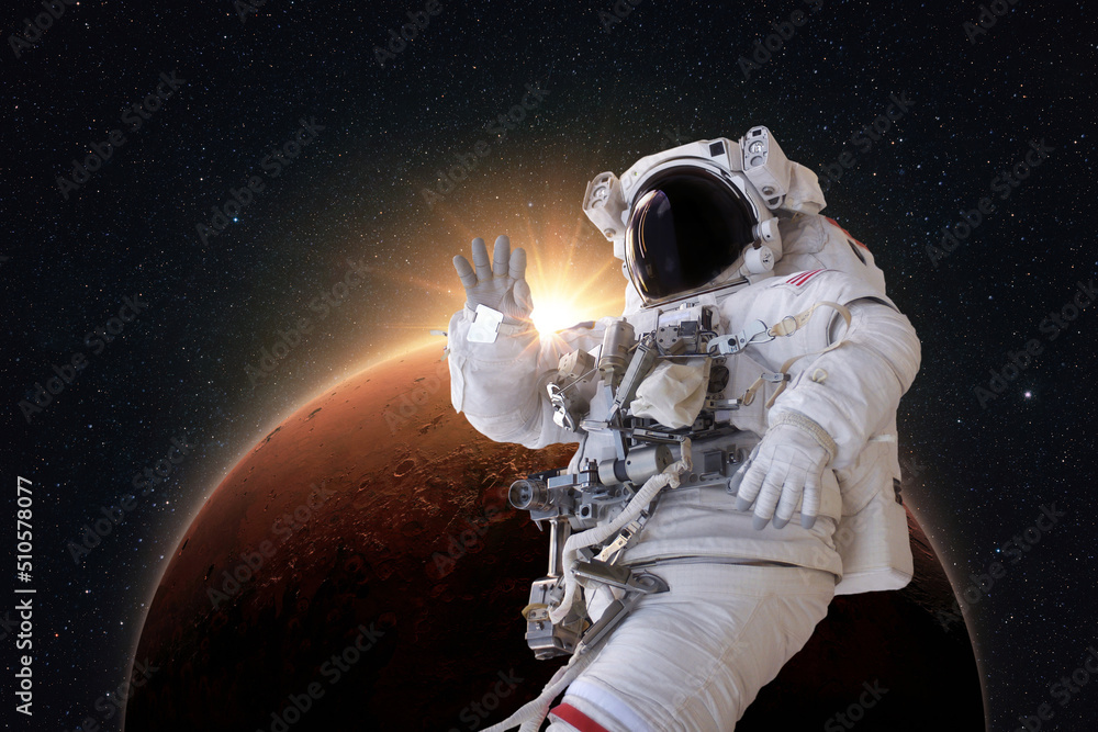 Successful astronaut in a space suit levitates in space and explores ...