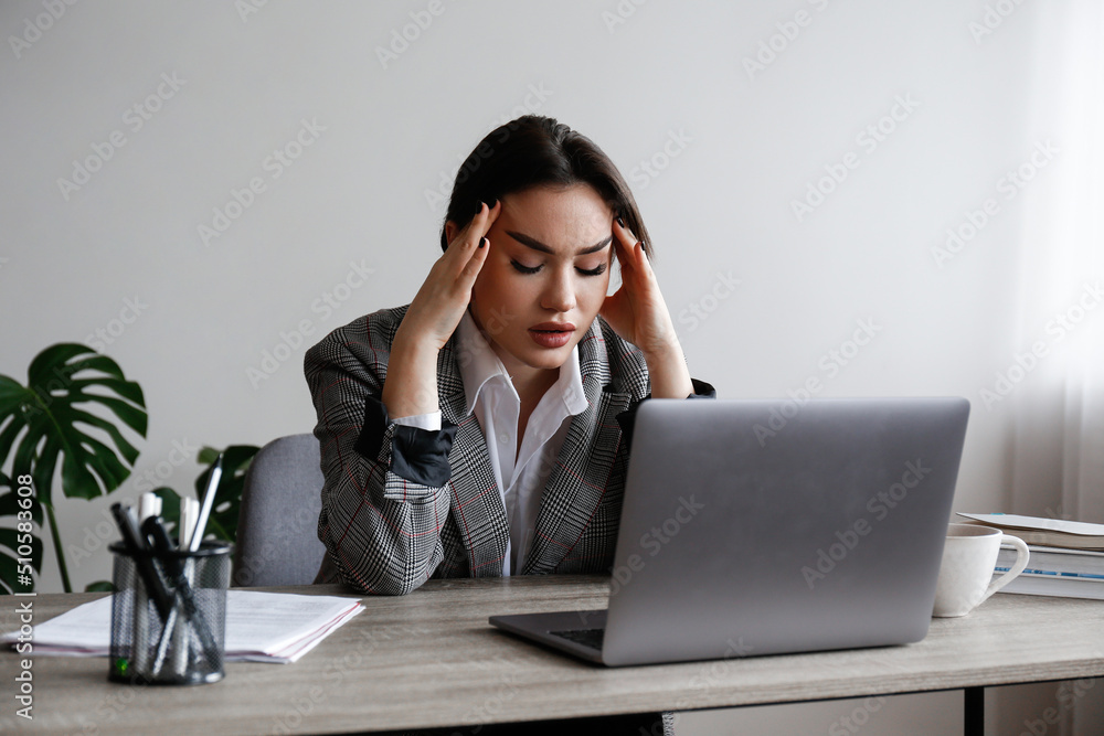 Portrait of a young businesswoman in a state of emotional, physical and ...
