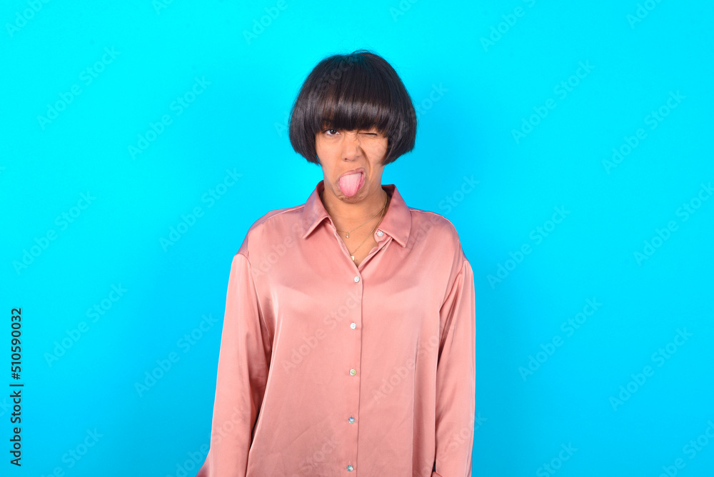 Body language. Disgusted stressed out young brunette woman wearing pink ...