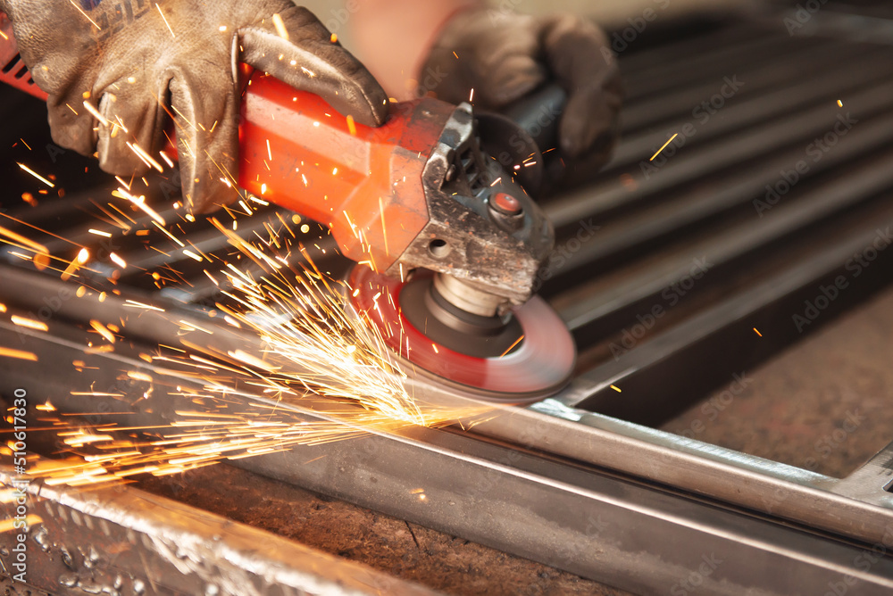Professional male blacksmith forming red hot metal on an anvil in ...