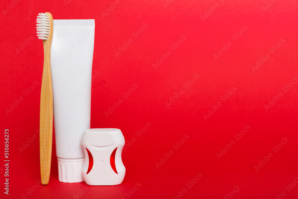 toothpaste and toothbrush top view with copy space on colored ...