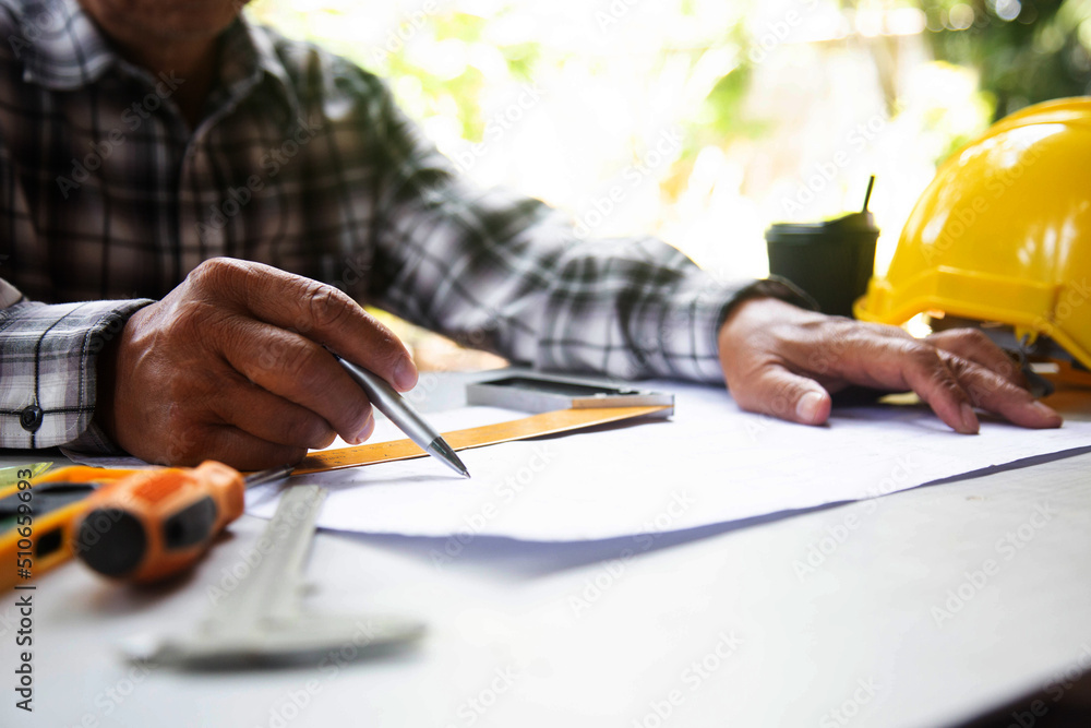 Architect asian old man drawings with blueprint at Construction Site ...