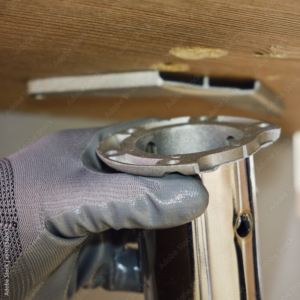 Broken leg of an office desk, repair of furniture made of wood and ...