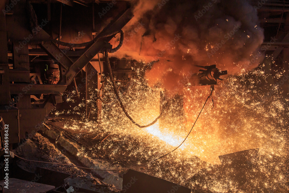 Hot red melting slag is pouring from blast furnace tap hole. Stock ...