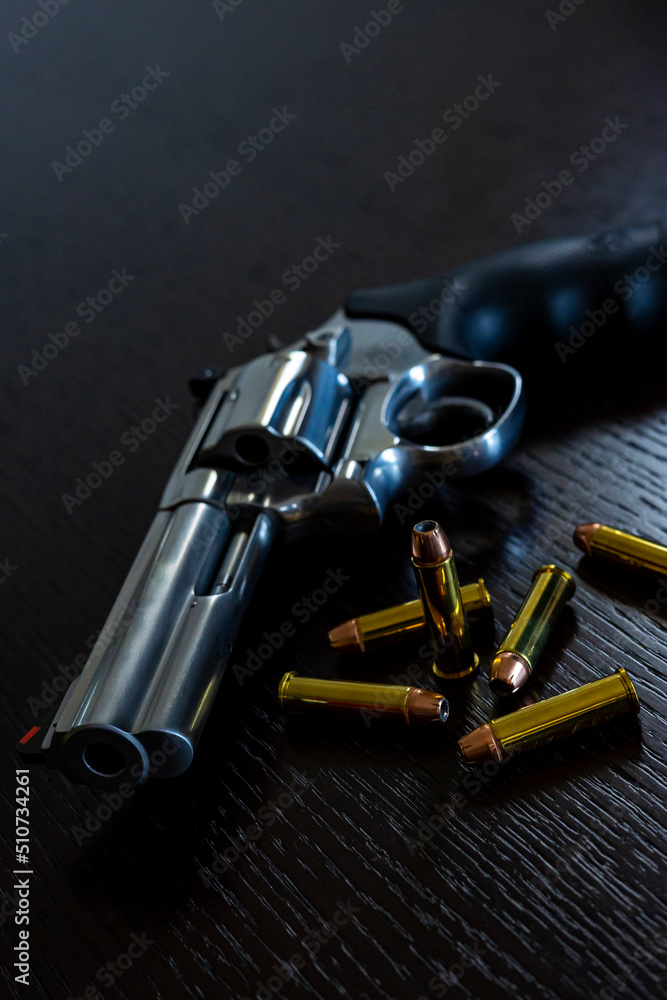 Artistic photo of a 357 magnum caliber revolver on a dark wood grain ...