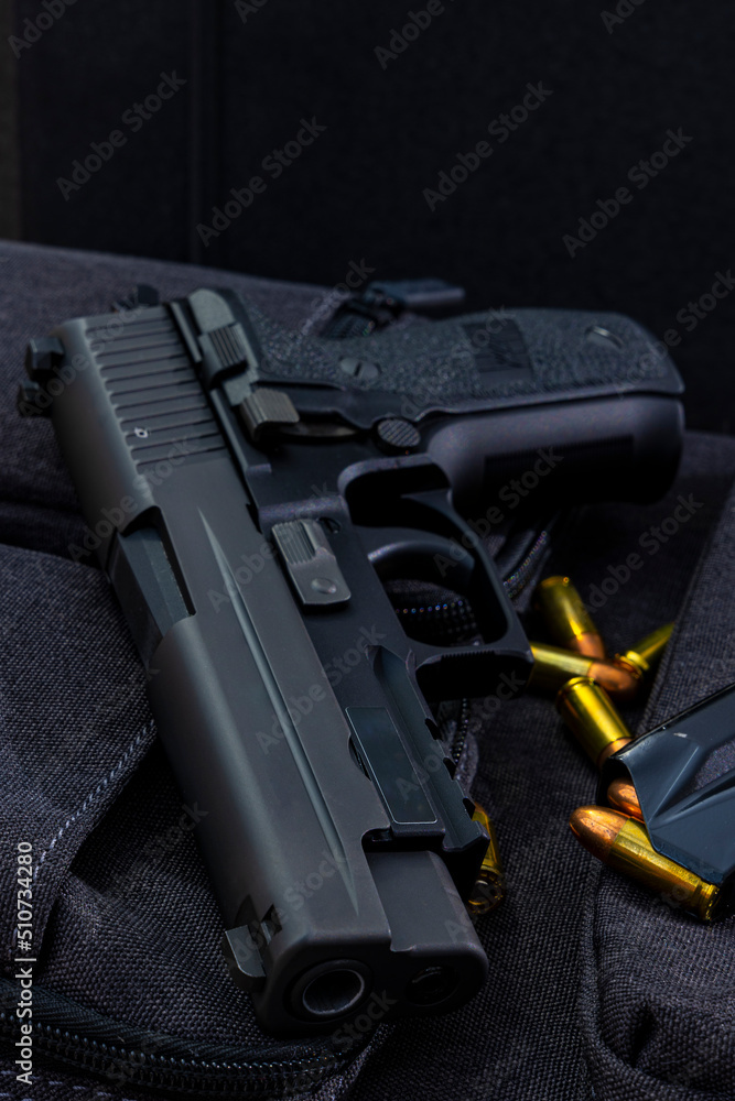 Artistic photo of a semi automatic 9mm handgun on a black background in ...