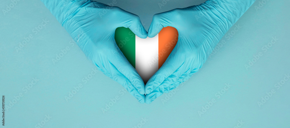 Doctors hands wearing blue surgical gloves making hear shape symbol ...