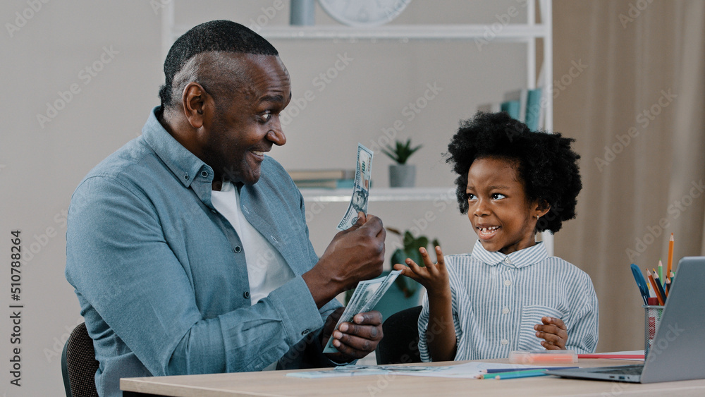 African american father helps to do homework teaches little daughter ...