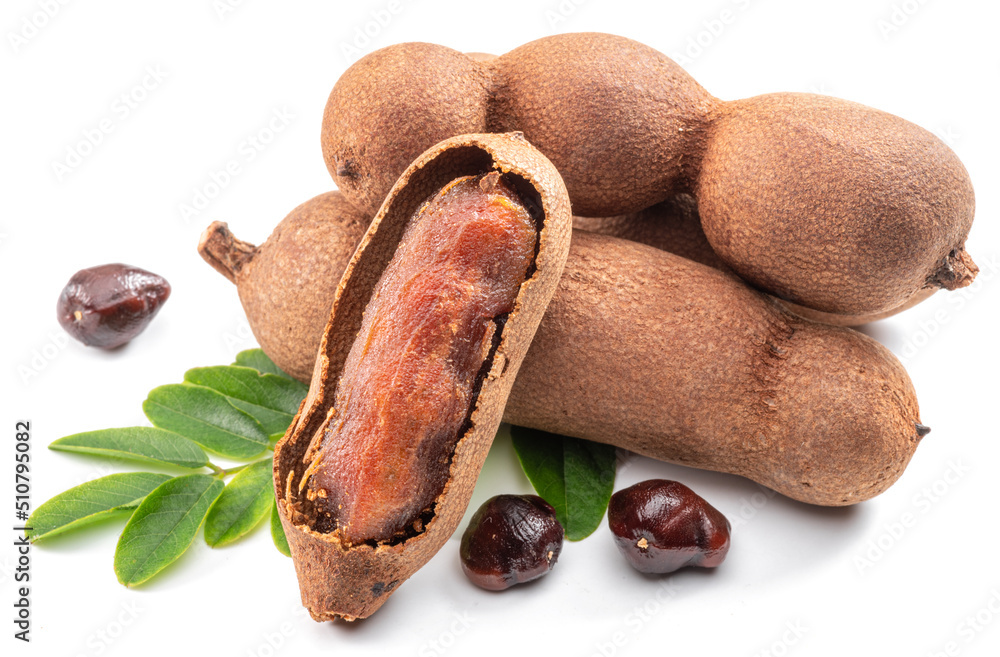 Ripe tamarind fruit, leaves and some tamarind seeds isolated on white ...