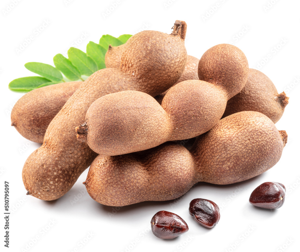 Ripe tamarind fruit, leaves and some tamarind seeds isolated on white ...