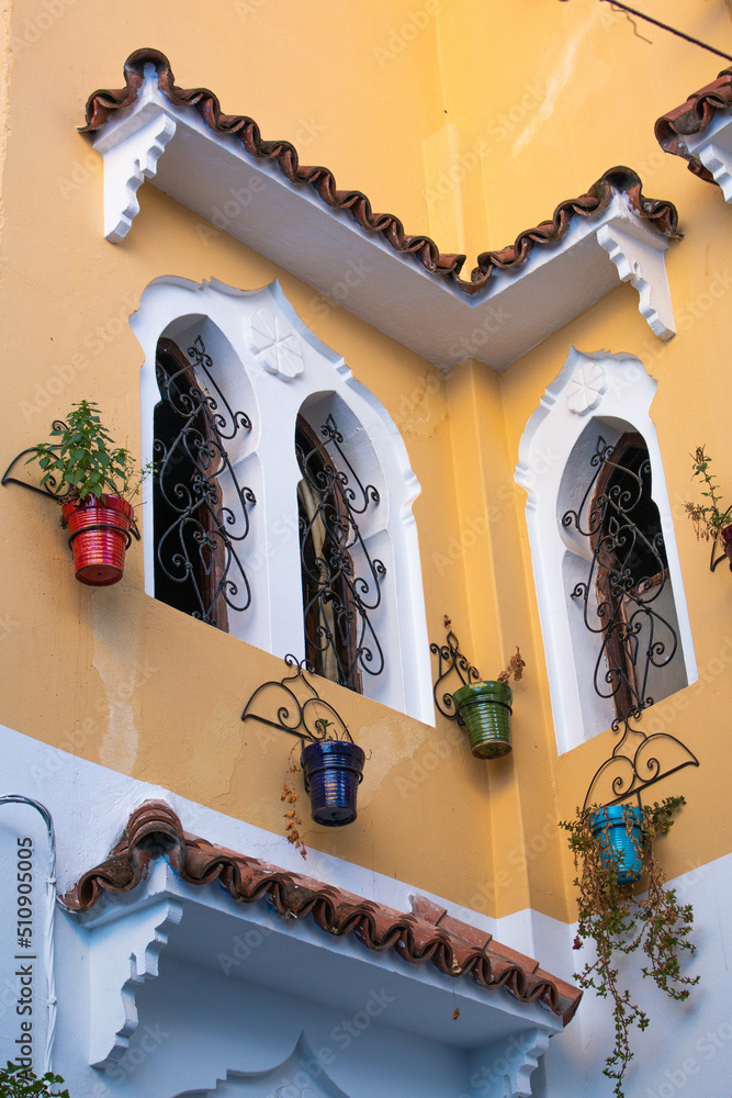 beautiful white Arabic windows with black bars and a small roof, on a ...