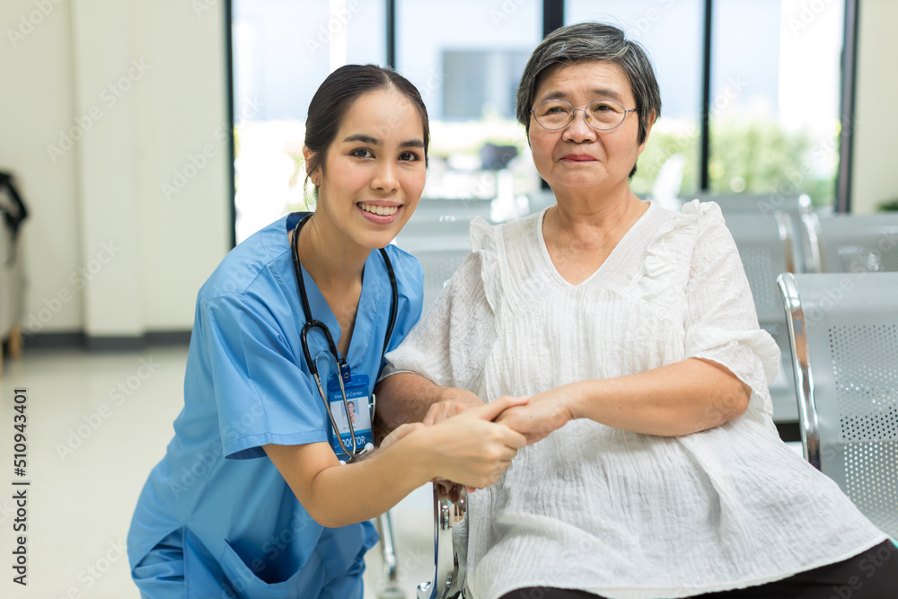 Nurse take care Elderly patient in hospital ward. Elderly woman sit ...