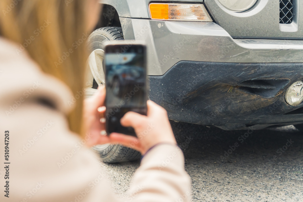 Unrecognizable person using mobile smartphone to take a photo of car ...