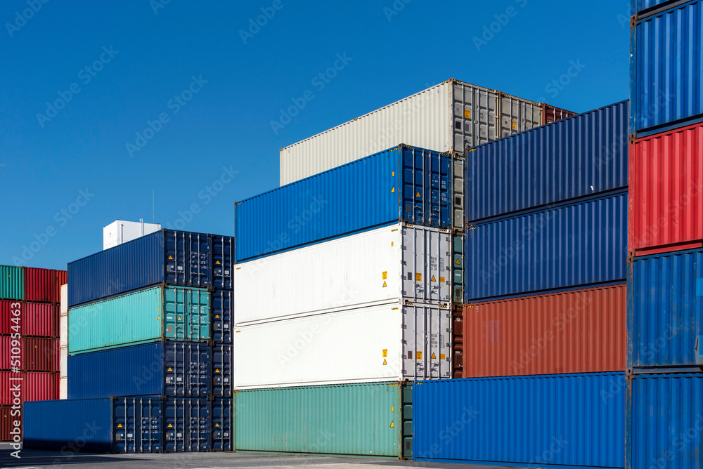 shipping containers stacked and stored in a container yard: Logistics ...