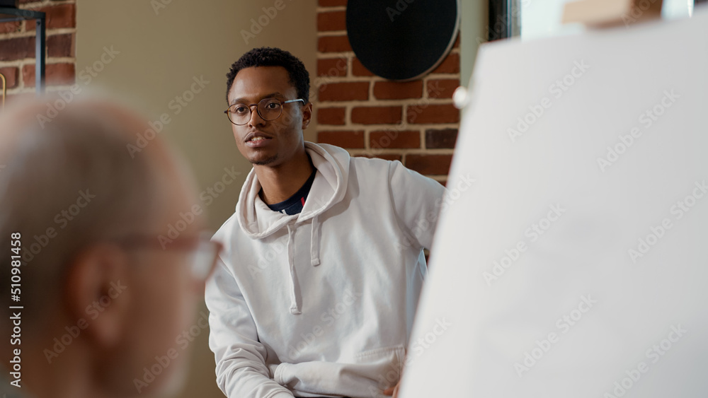 Artist teaching art student to draw sketch at creative workshop ...