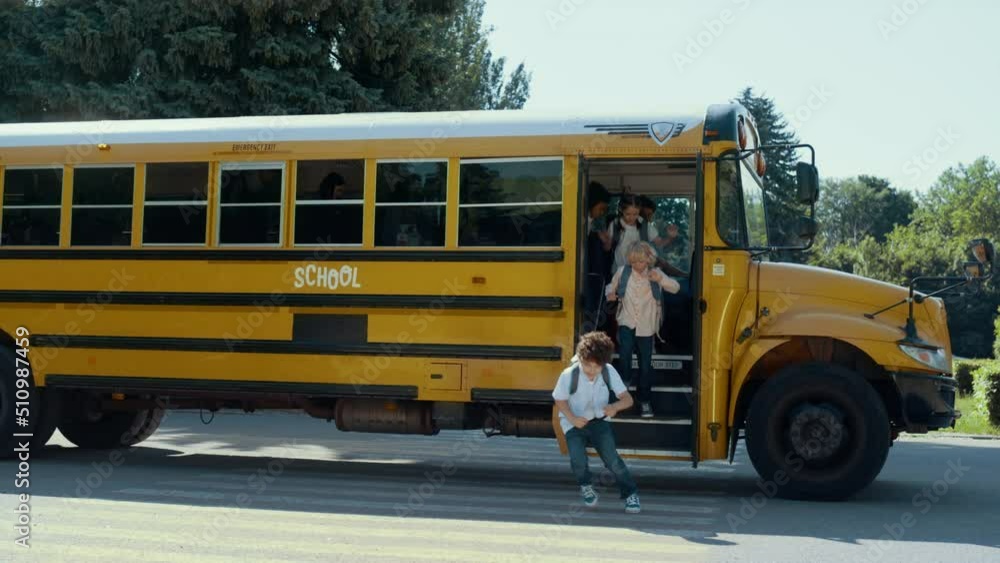Smiling students leaving yellow school bus. Joyful pupils running on ...