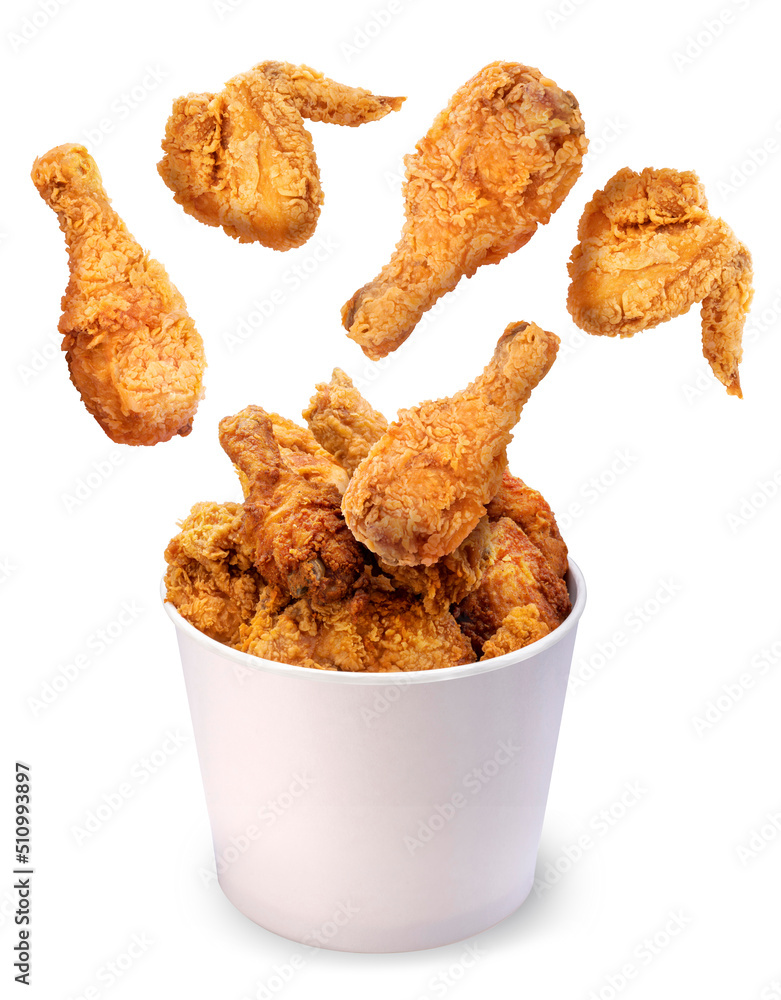 Fried chicken flying out of paper bucket isolated on white background ...