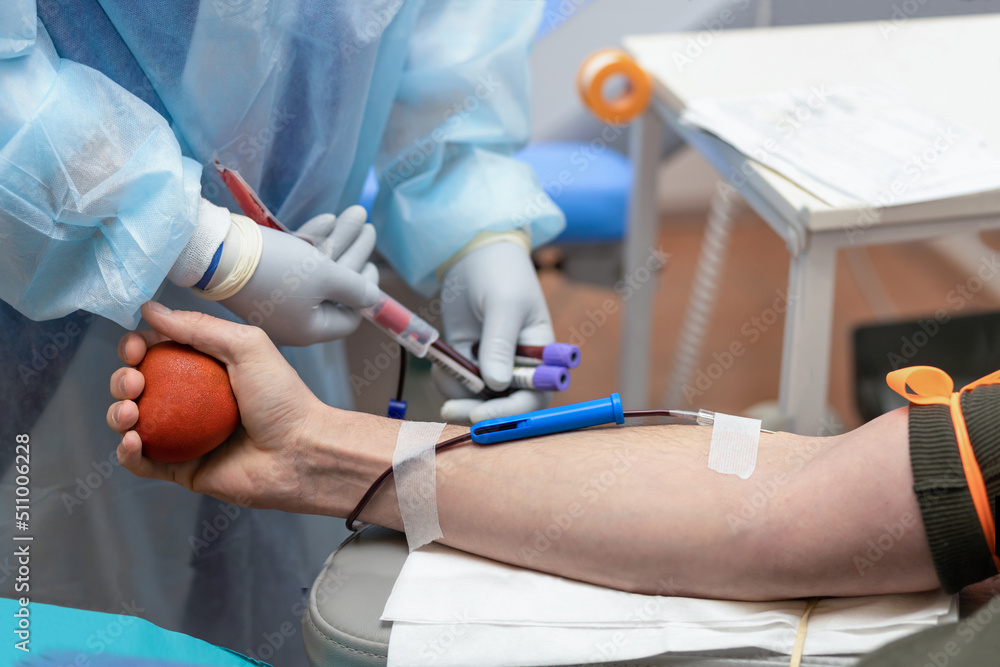 bone marrow donation. male hand holding red ball, man with blood ...