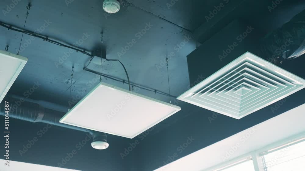 Handheld, view of the ventilation and lighting system of office ...