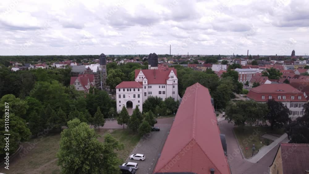fly into front of Köthen castle entrance in Germany during cloudy day ...