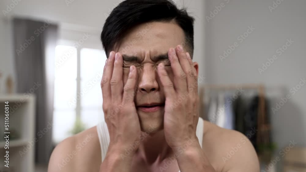 front shoulder shot asian young man looking at camera as mirror is ...