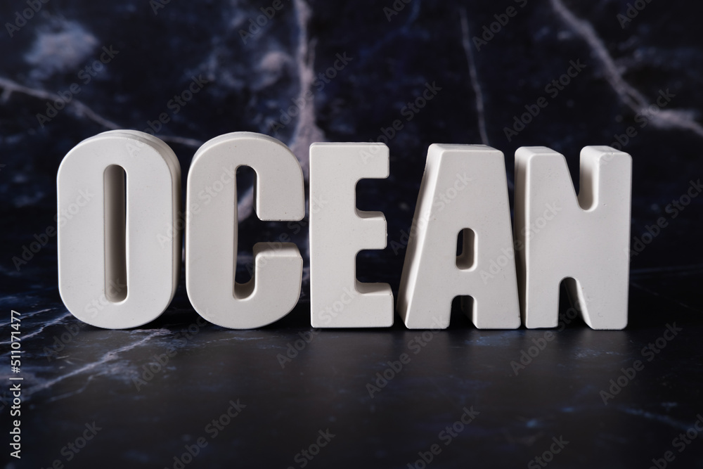 Word Ocean made from white concrete letters on the blue background ...