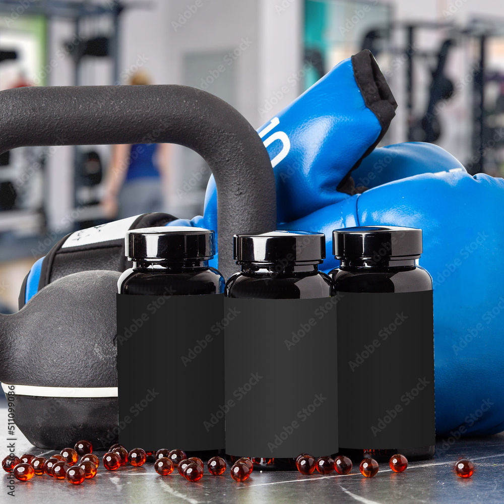 Black jar with sports nutrition red capsules with kettlebells and ...