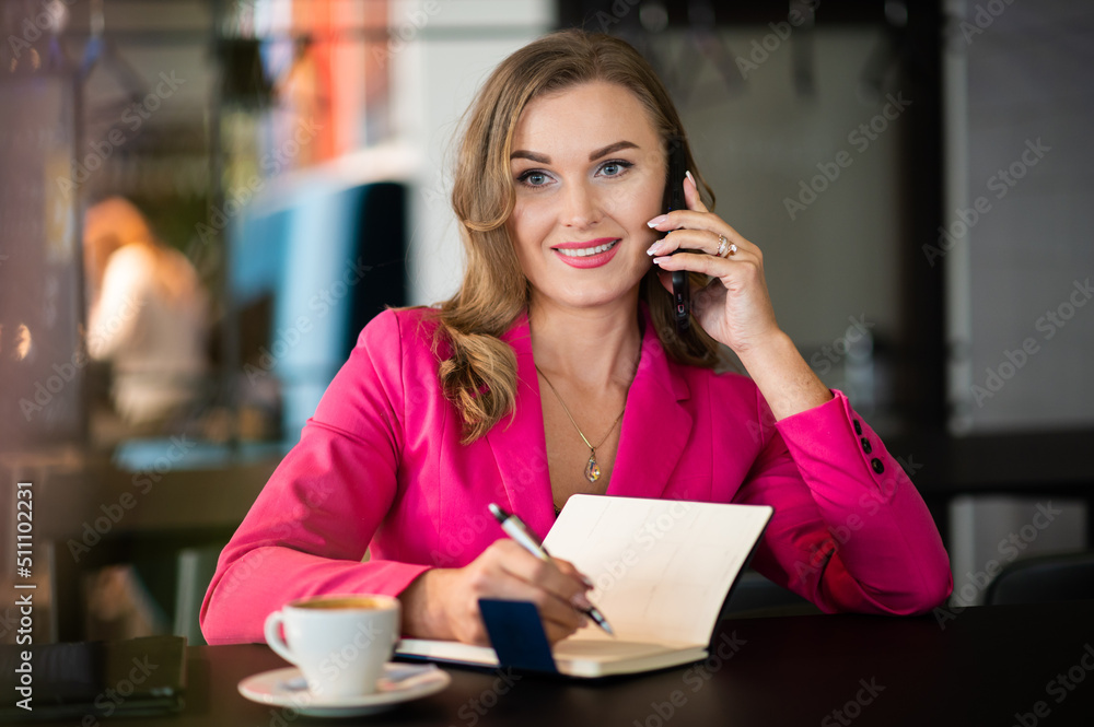 Beautiful woman having a coffee in a cafe while working Stock Photo ...